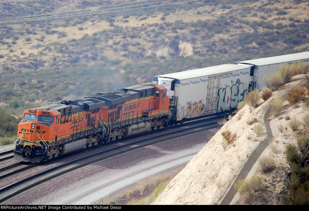 BNSF ES-44DC #7748 is part of a DPU set on a westbound